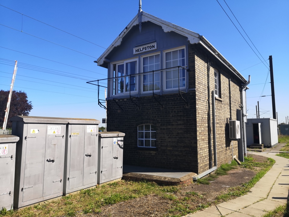 East Coast Main Line level crossing barriers lift with freight train ...